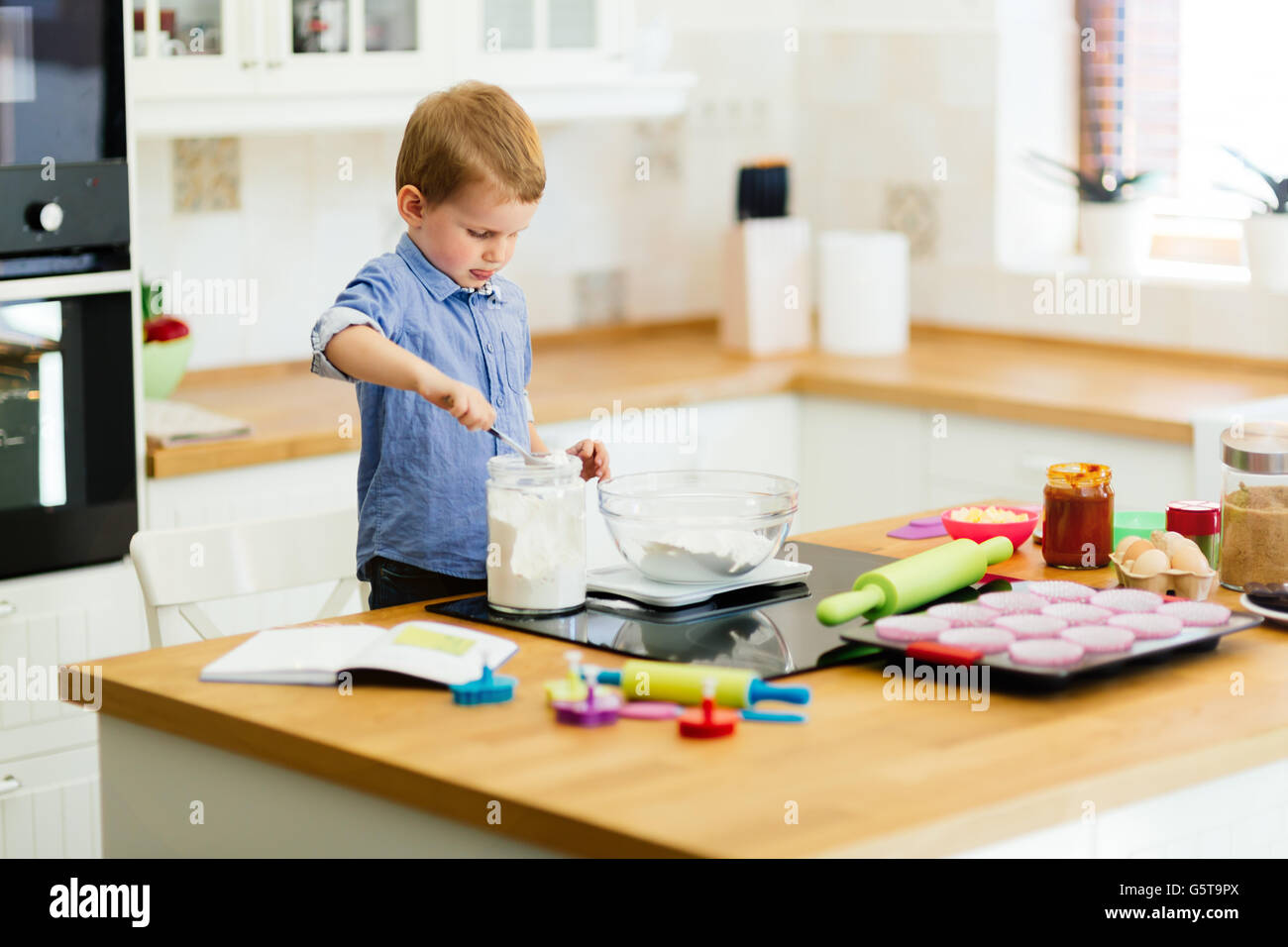 Adorable child below the age of 3 making cookies in kitchen Stock Photo ...