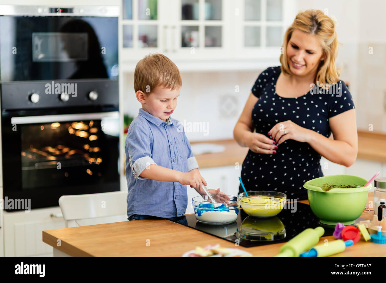 Beautiful child and mother baking in kitchen with love Stock Photo - Alamy