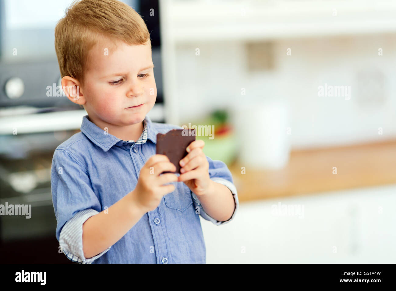 Child eating bar of chocolate hi-res stock photography and images - Alamy