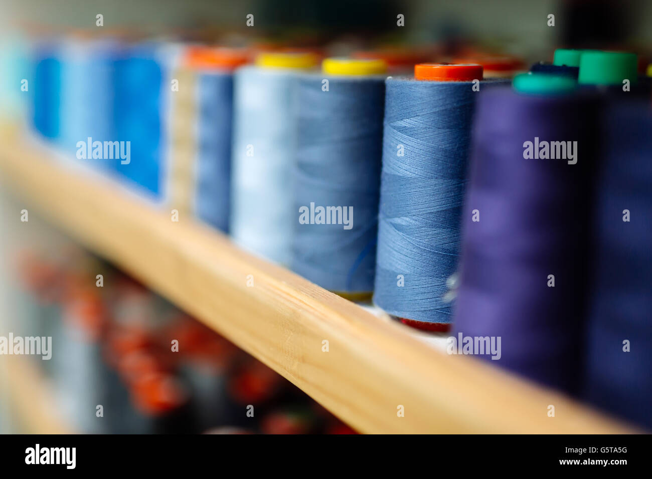 Colorful thread spools in fabric industry Stock Photo - Alamy