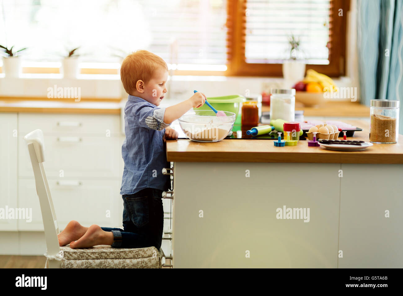 Adorable child below the age of 3 making cookies in kitchen Stock Photo ...