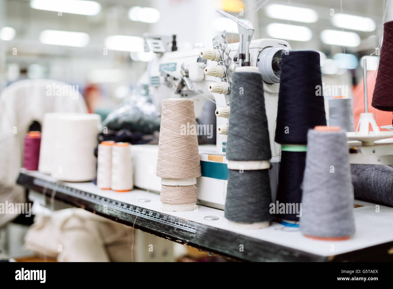 Wool and thread spools on desk used in textile industry Stock Photo - Alamy