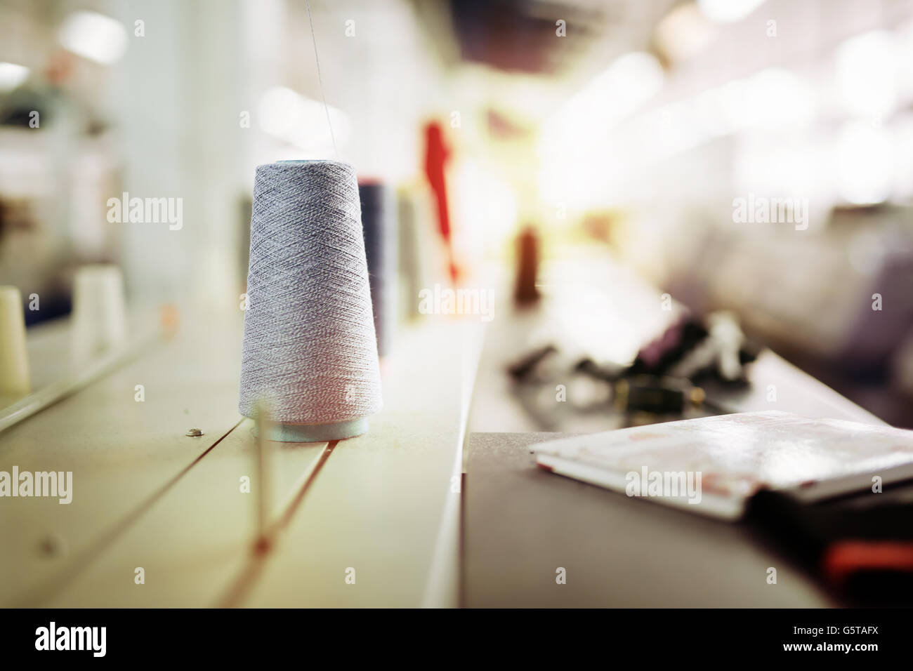 Wool and thread spools on desk used in textile industry Stock Photo - Alamy