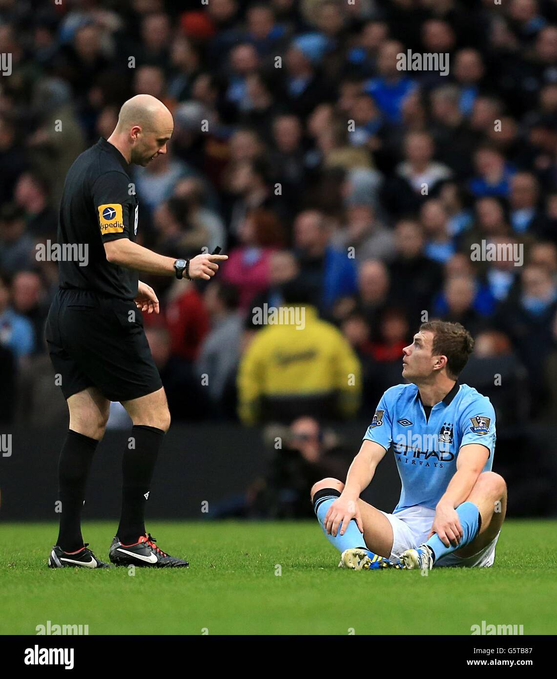 Manchester City's Edin Dzeko (right) speaks with match referee Anthony ...