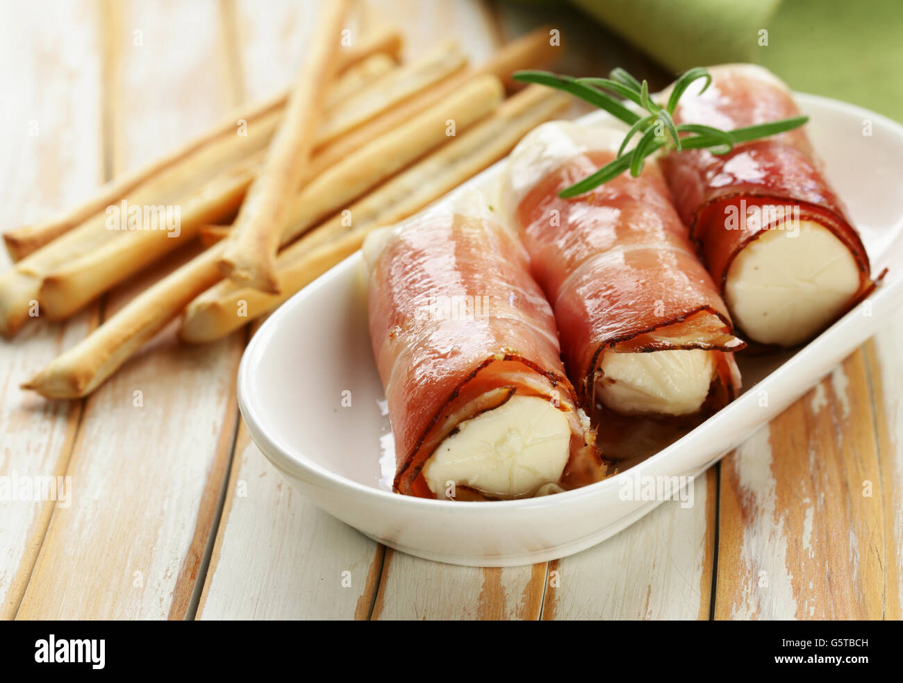 Italian appetizer soft cheese wrapped in parma ham Stock Photo - Alamy