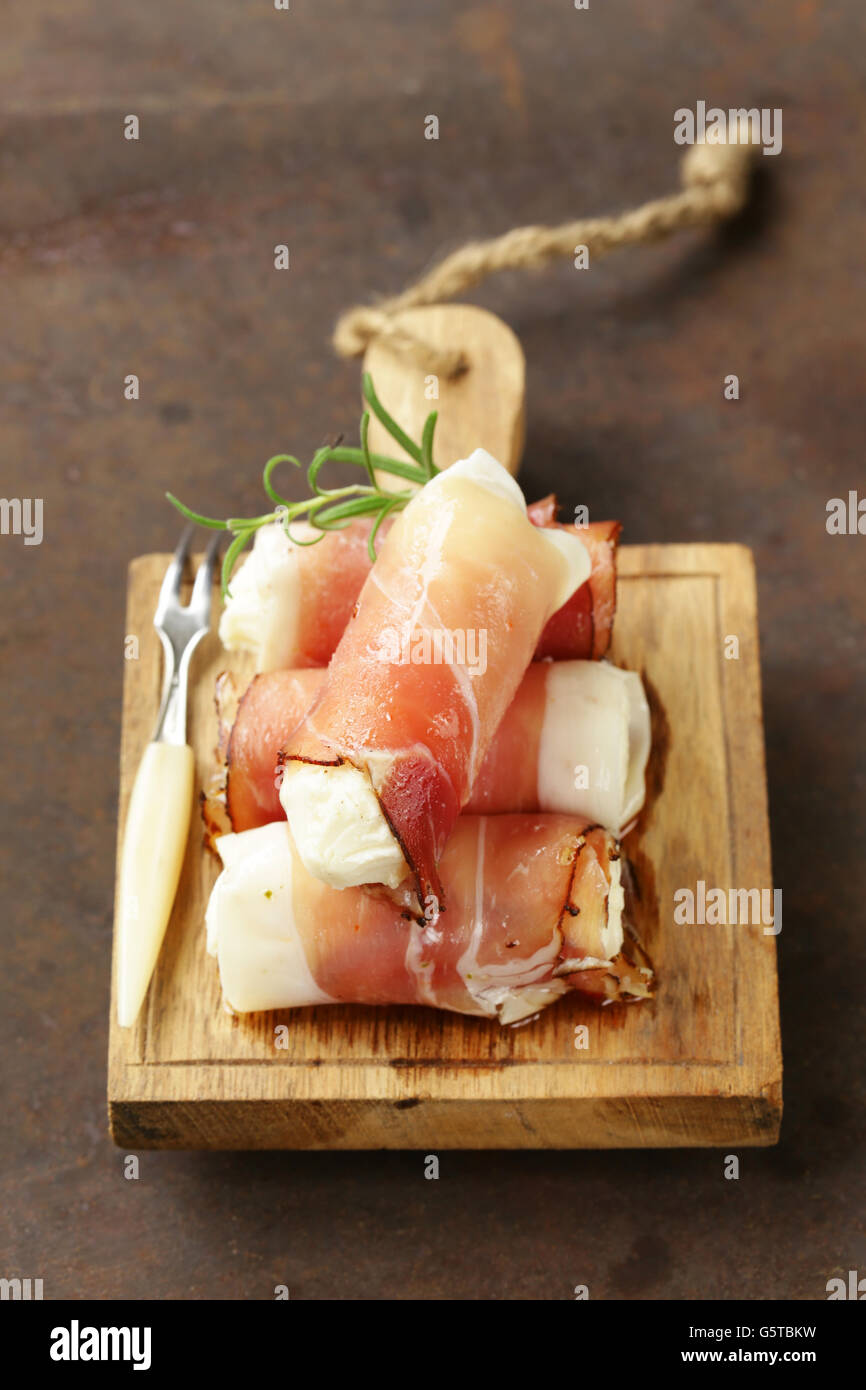 Italian appetizer soft cheese wrapped in parma ham Stock Photo - Alamy