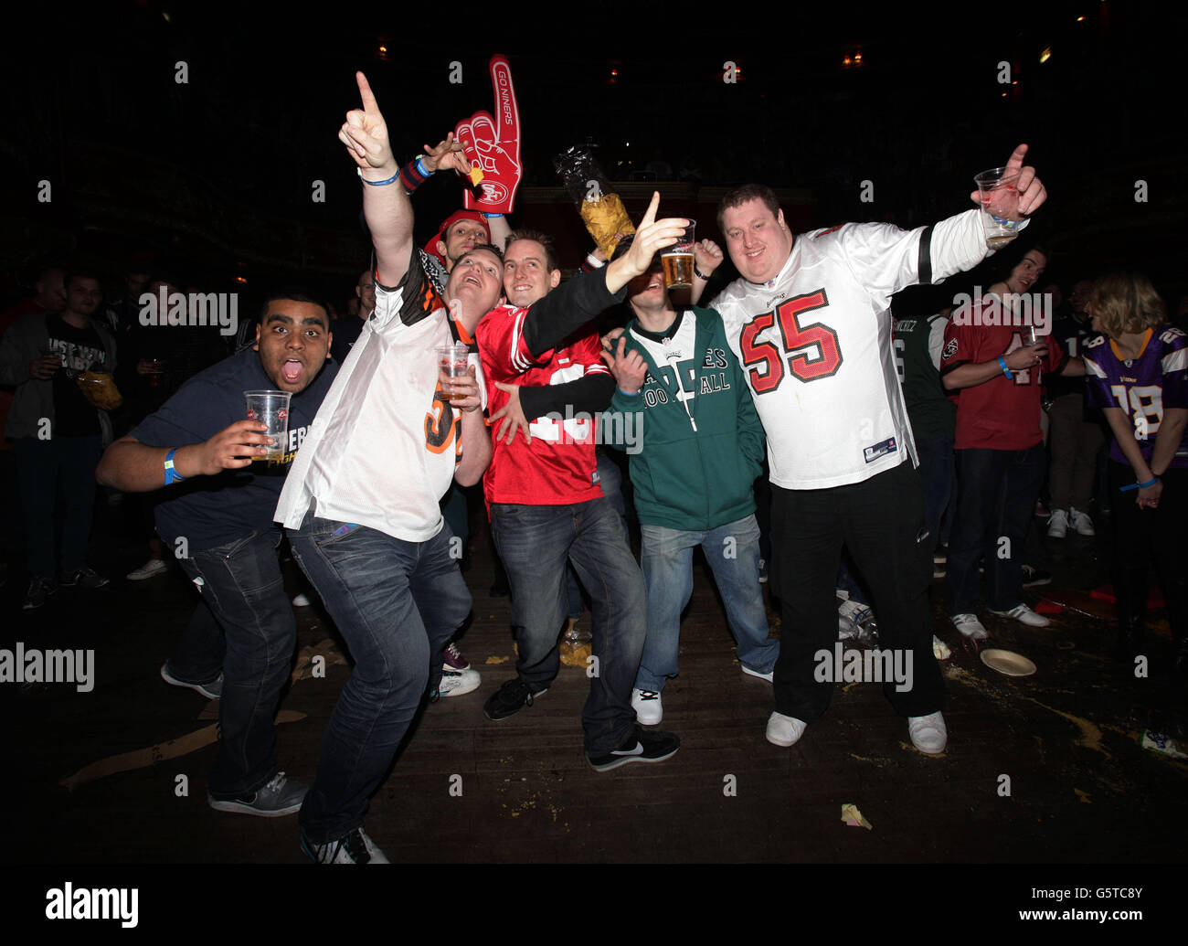 Fans watching the game on a giant screen, during the NFL Superbash ...