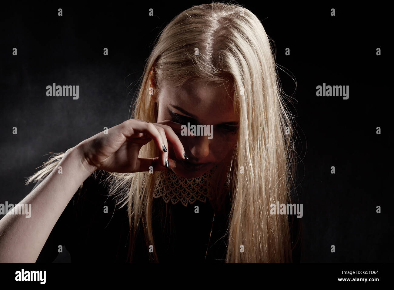 sad woman crying on black background Stock Photo - Alamy