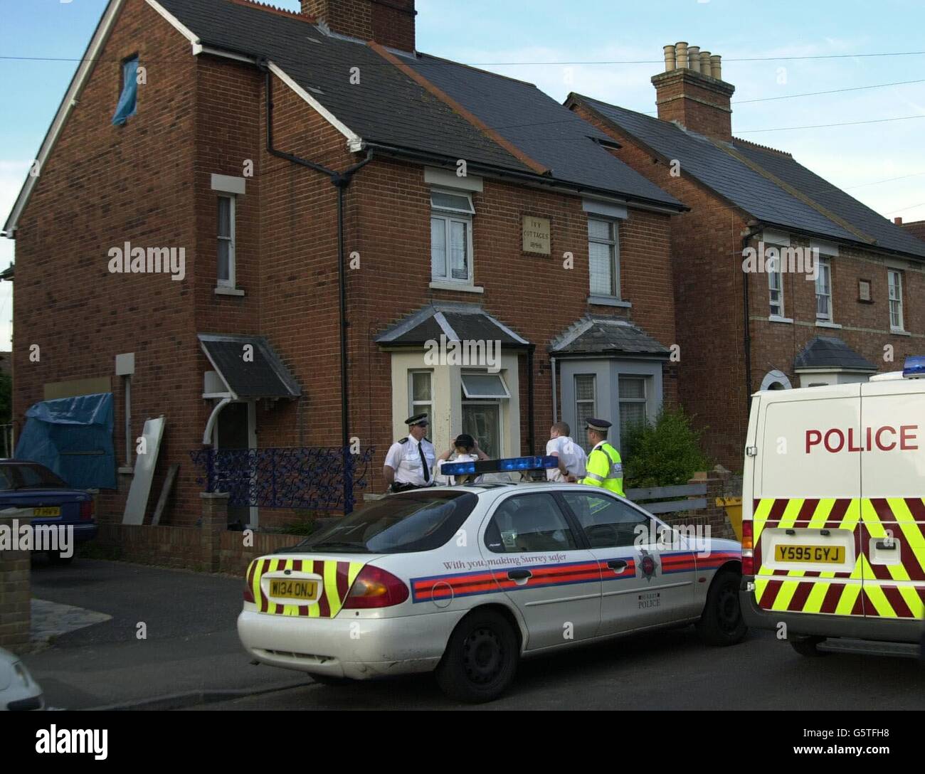 Police continue to search the house (left), in Abbey Road, Slough ...