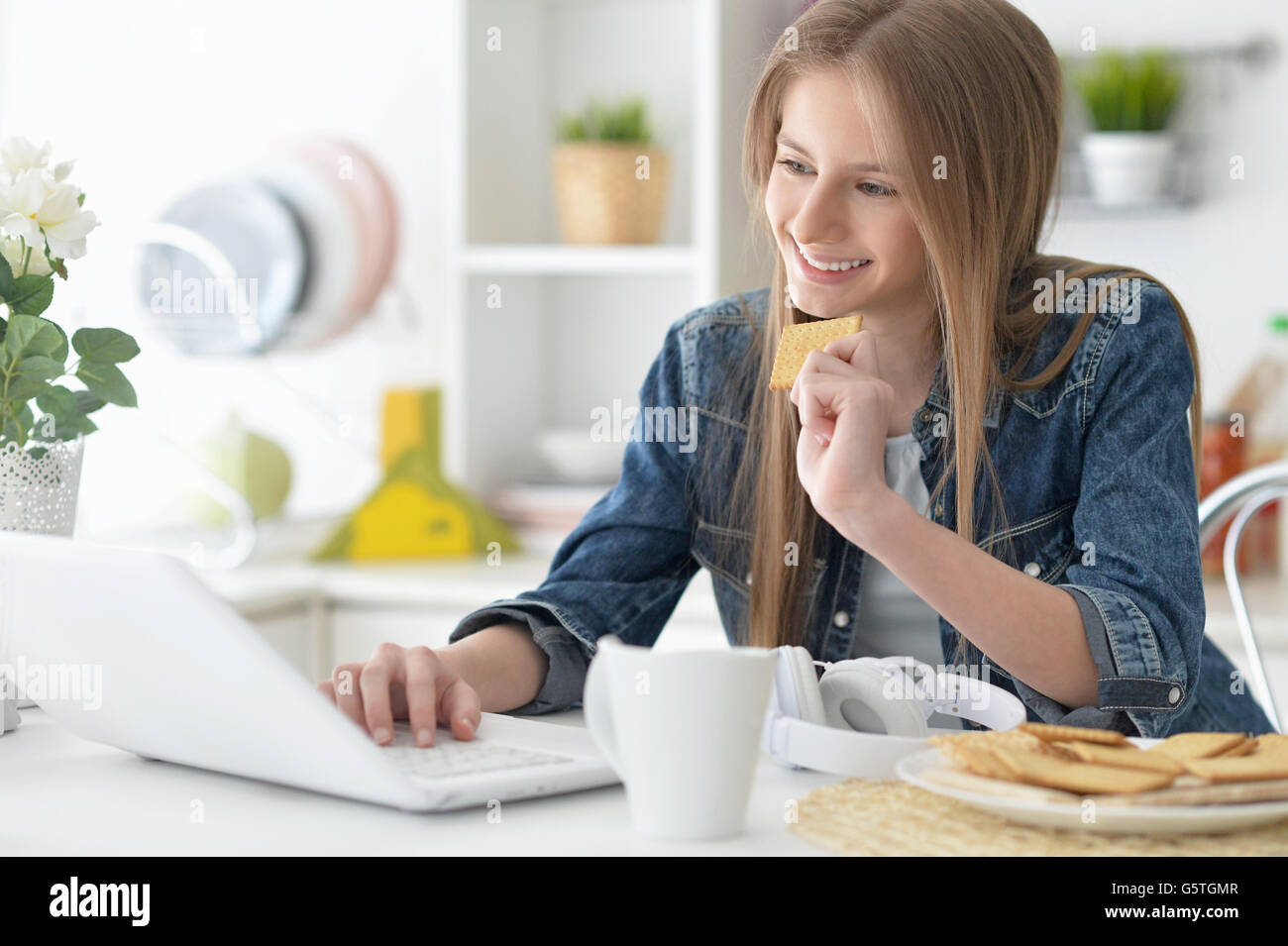 Portrait of a happy girl using laptop Stock Photo - Alamy