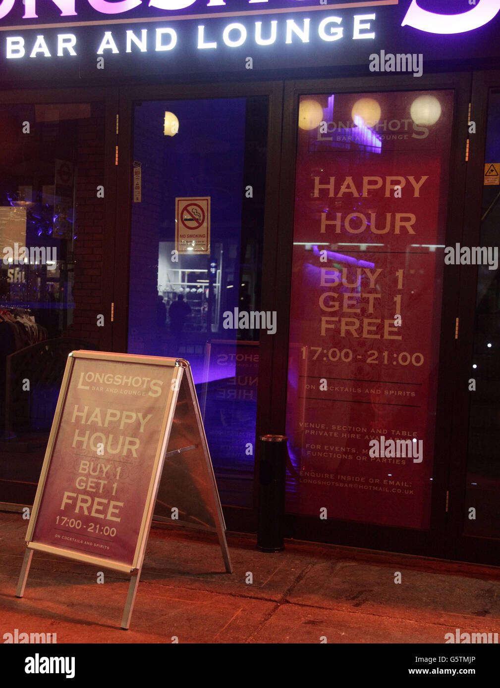 A 'happy hour' sign outside a bar on Charing Cross Road, central London ...