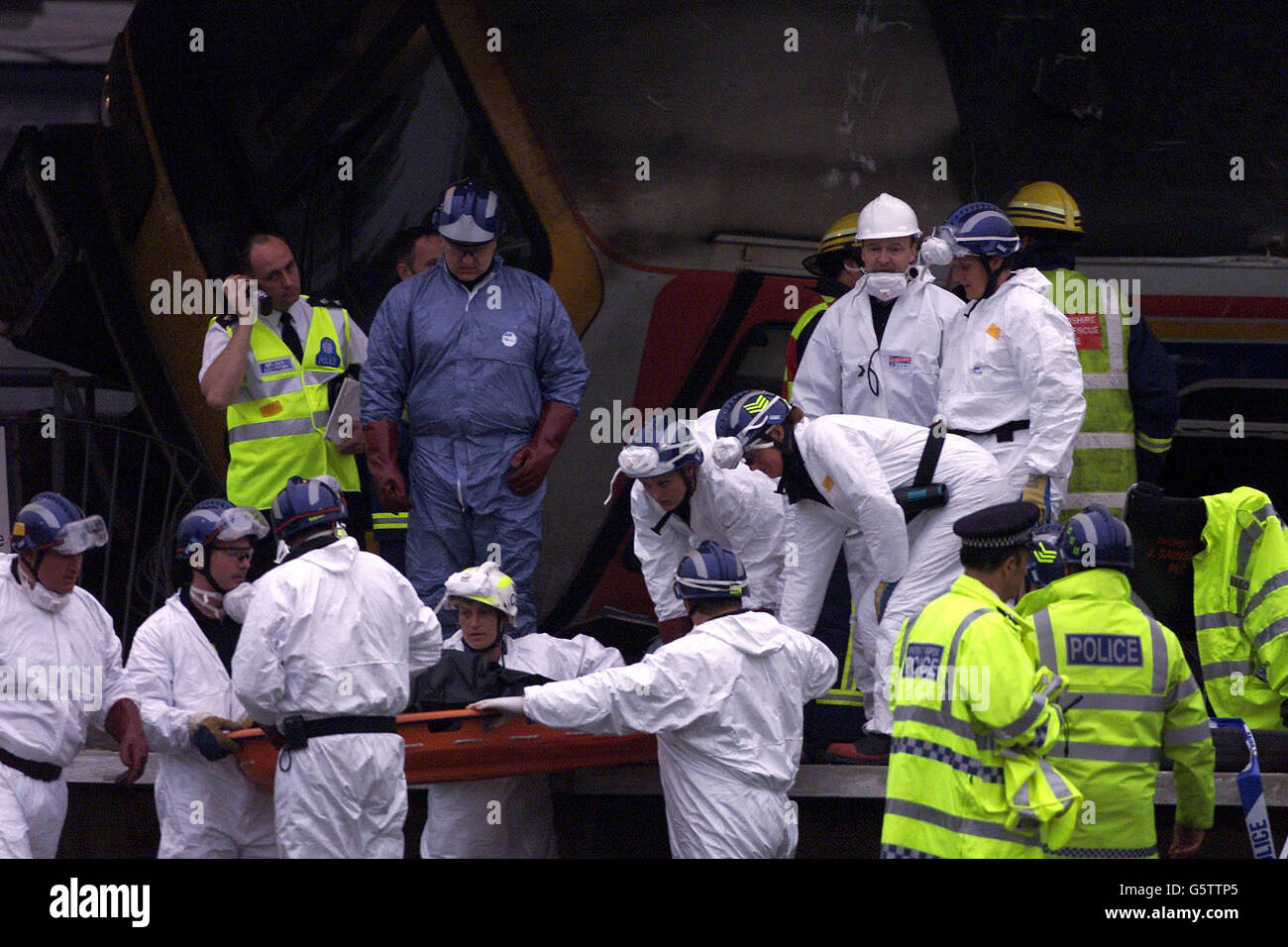 A body is removed from the wreckage at the scene of the rail crash, at ...