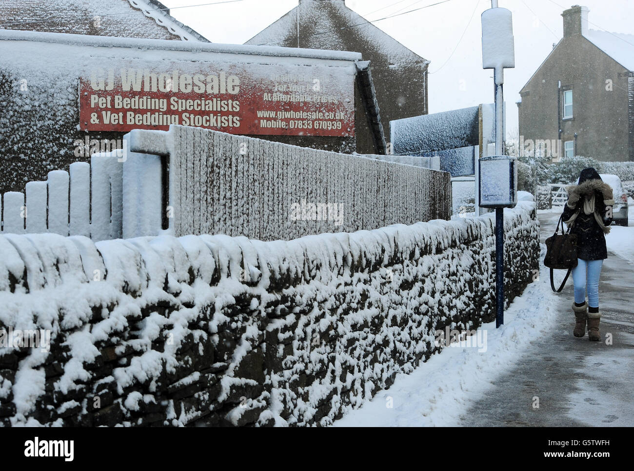 Woman makes her way along snow covered path in penistone hi-res stock ...
