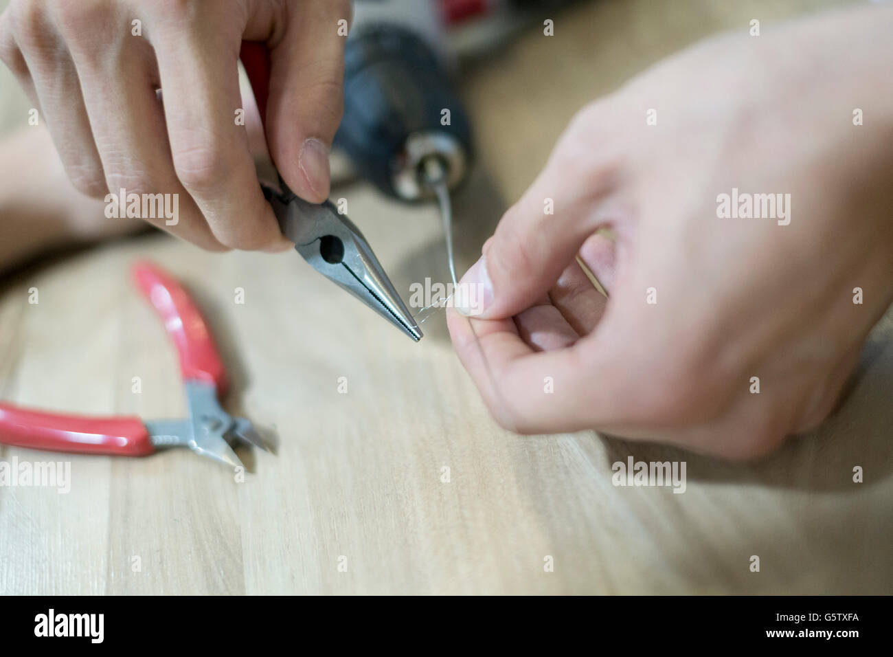 By means of the tool man's hands wind a spiral Stock Photo - Alamy