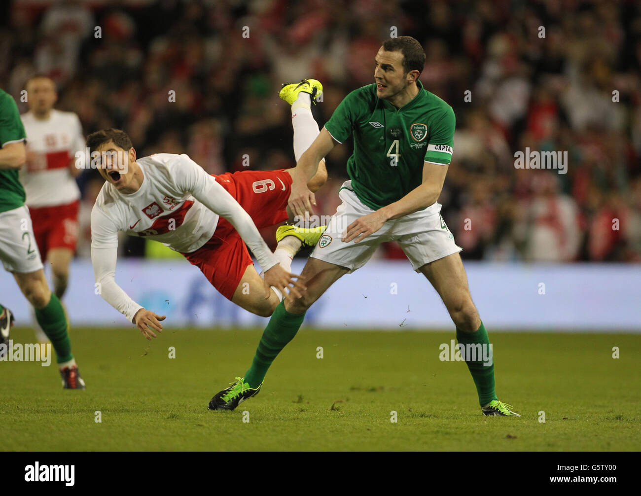 Ireland's John O'Shea (right) and Poland's Robert Lewandowski tussle ...
