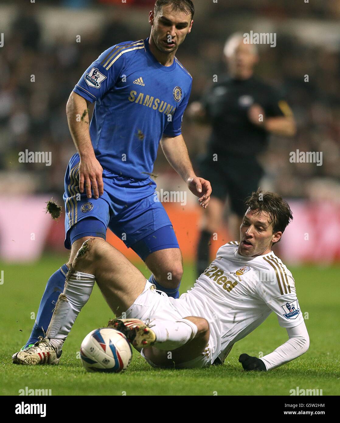 Chelsea's Branislav Ivanovic and Swansea City's Miguel Michu (floor ...
