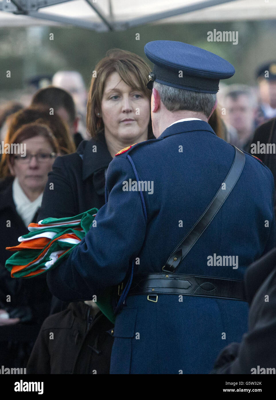Garda Commissioner Martin Callinan hands the Tricolour from Detective ...