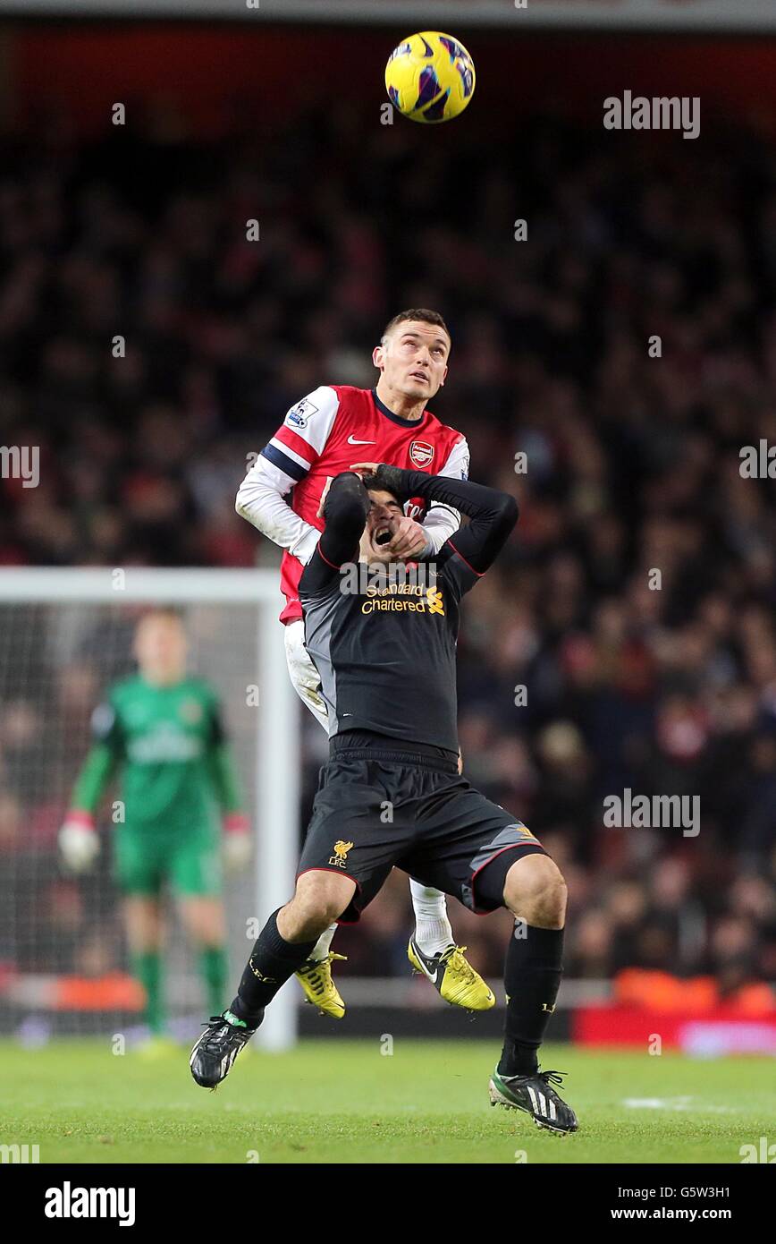 Liverpool's Luis Suarez (front) and Arsenal's Thomas Vermaelen (rear ...