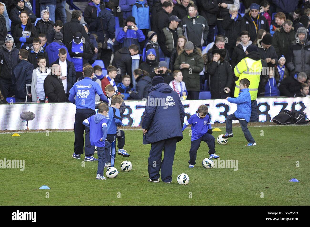 A children's coaching session on the pitch at half-time Stock Photo - Alamy