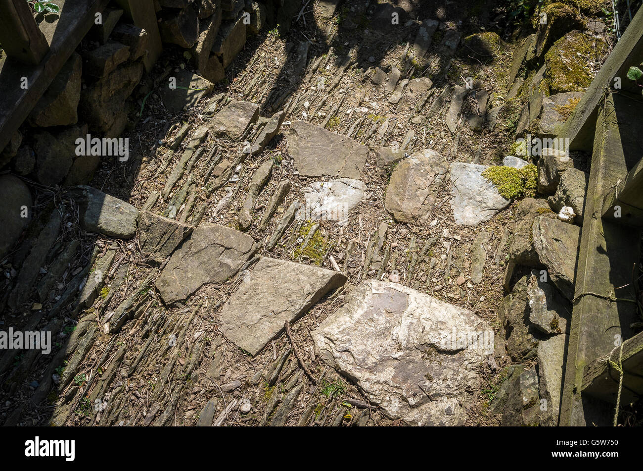 Garden path with steps made from natural stone pieces Stock Photo - Alamy