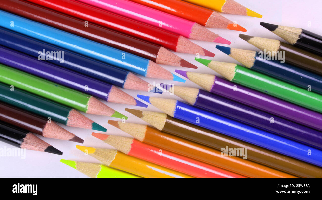 A set of colorful pencils facing each other, on a white sheet Stock ...