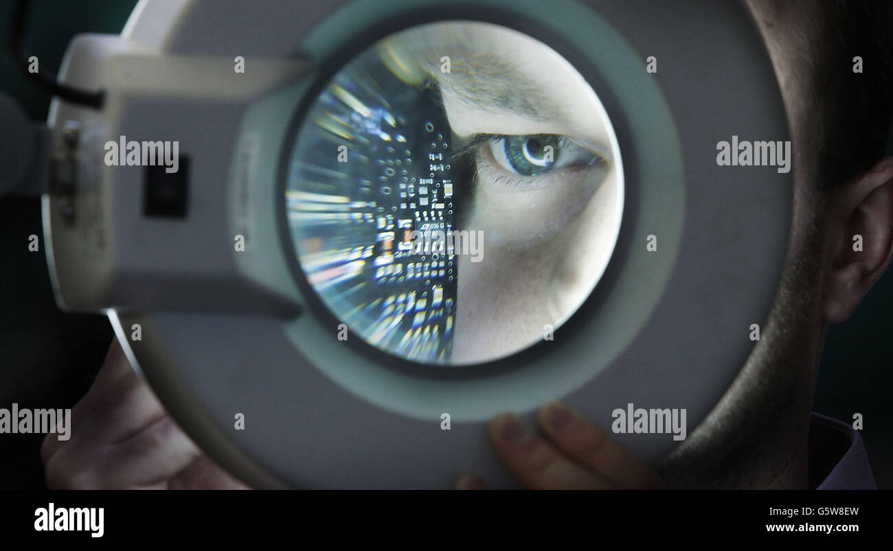 Kevin Worrall Senior Engineer Clyde Space looks at a component from the ...