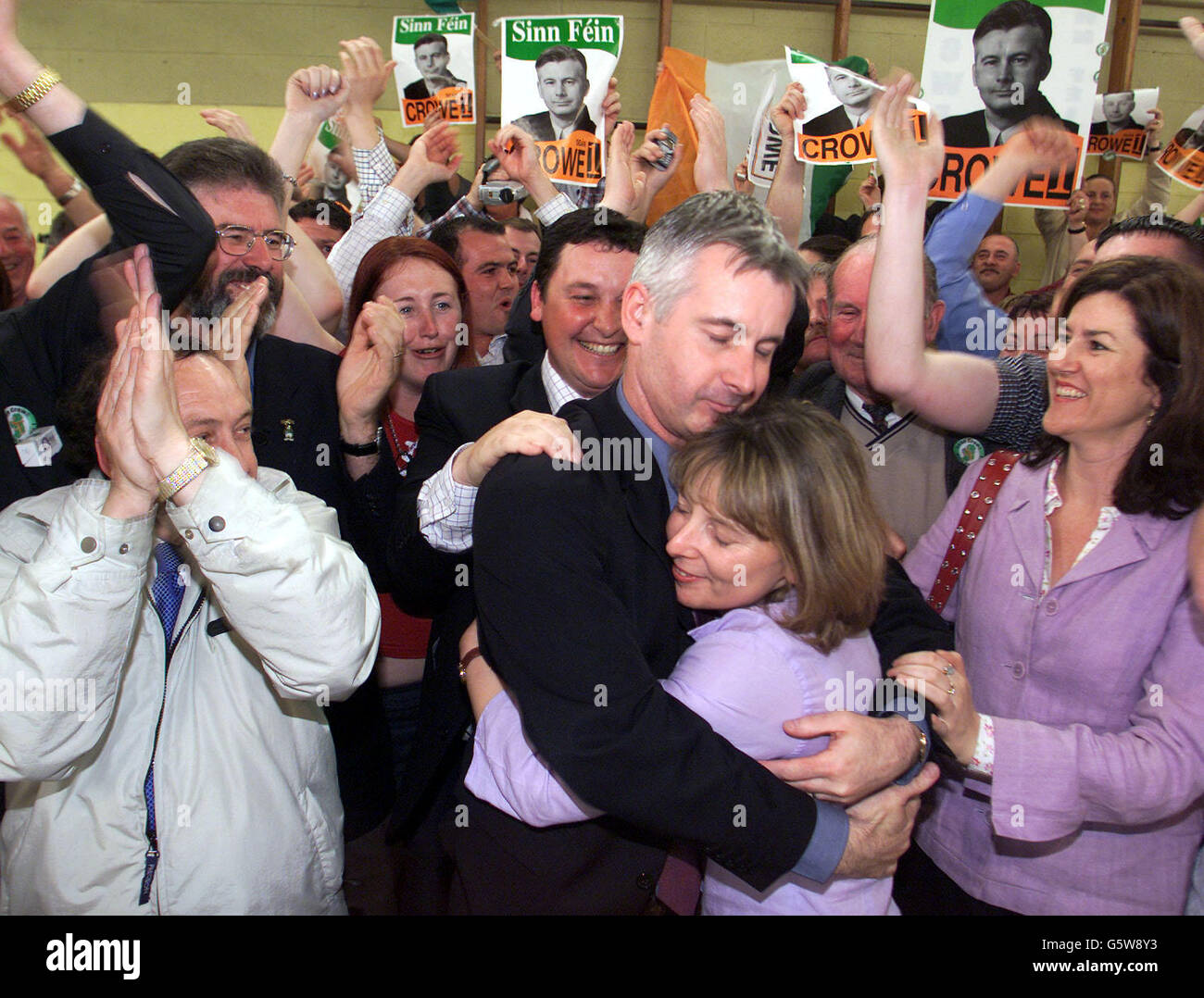 Sinn Fein's Sean Crowe is embraced by his wife Pamela and congratulated ...