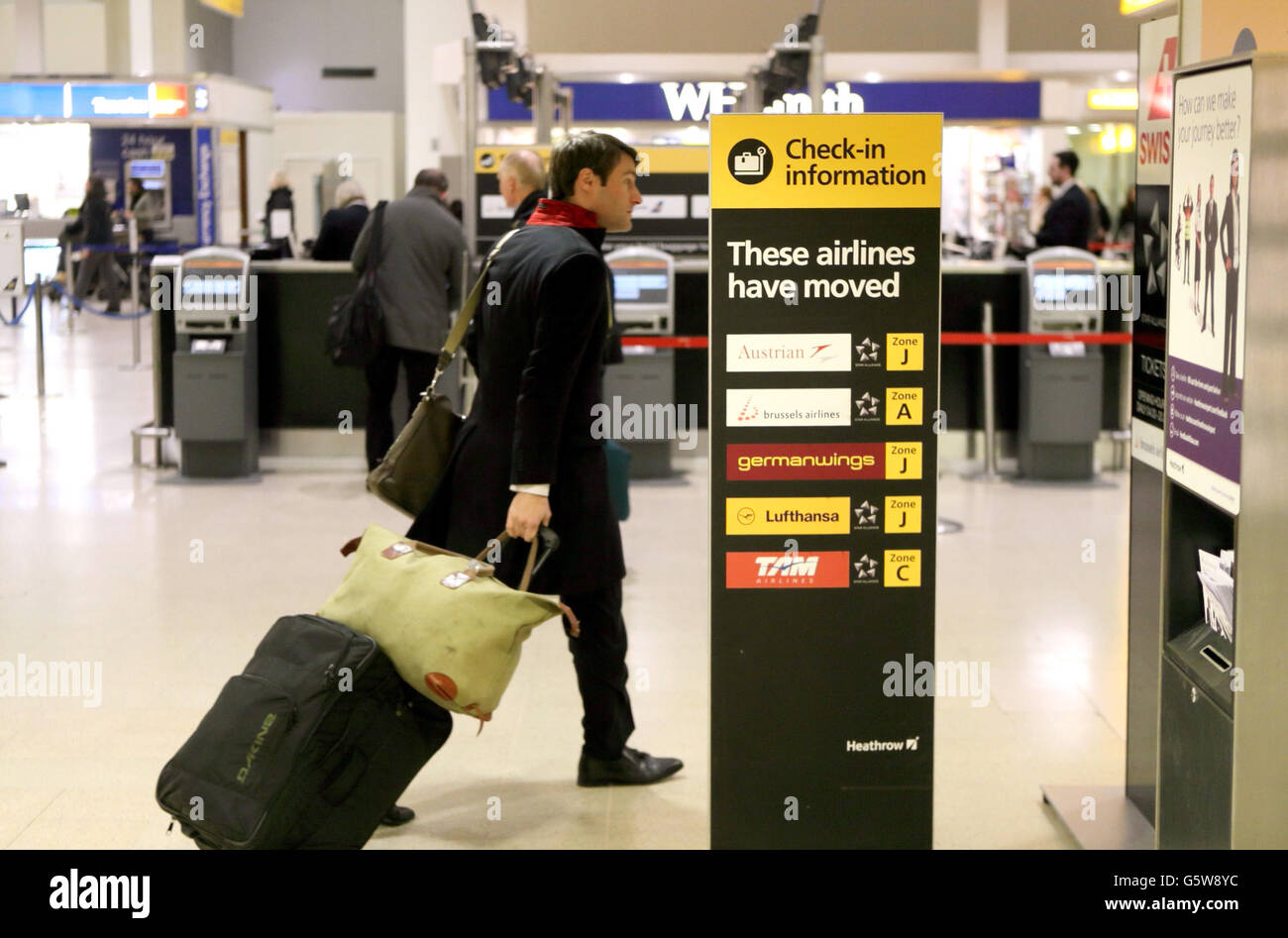 Heathrow Airport - Stock. A Passenger checks in at a in Terminal 1 of ...