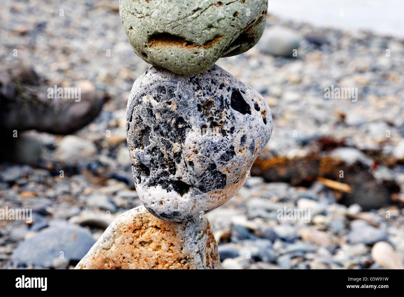 Stones balanced on a pebble beach Stock Photo - Alamy