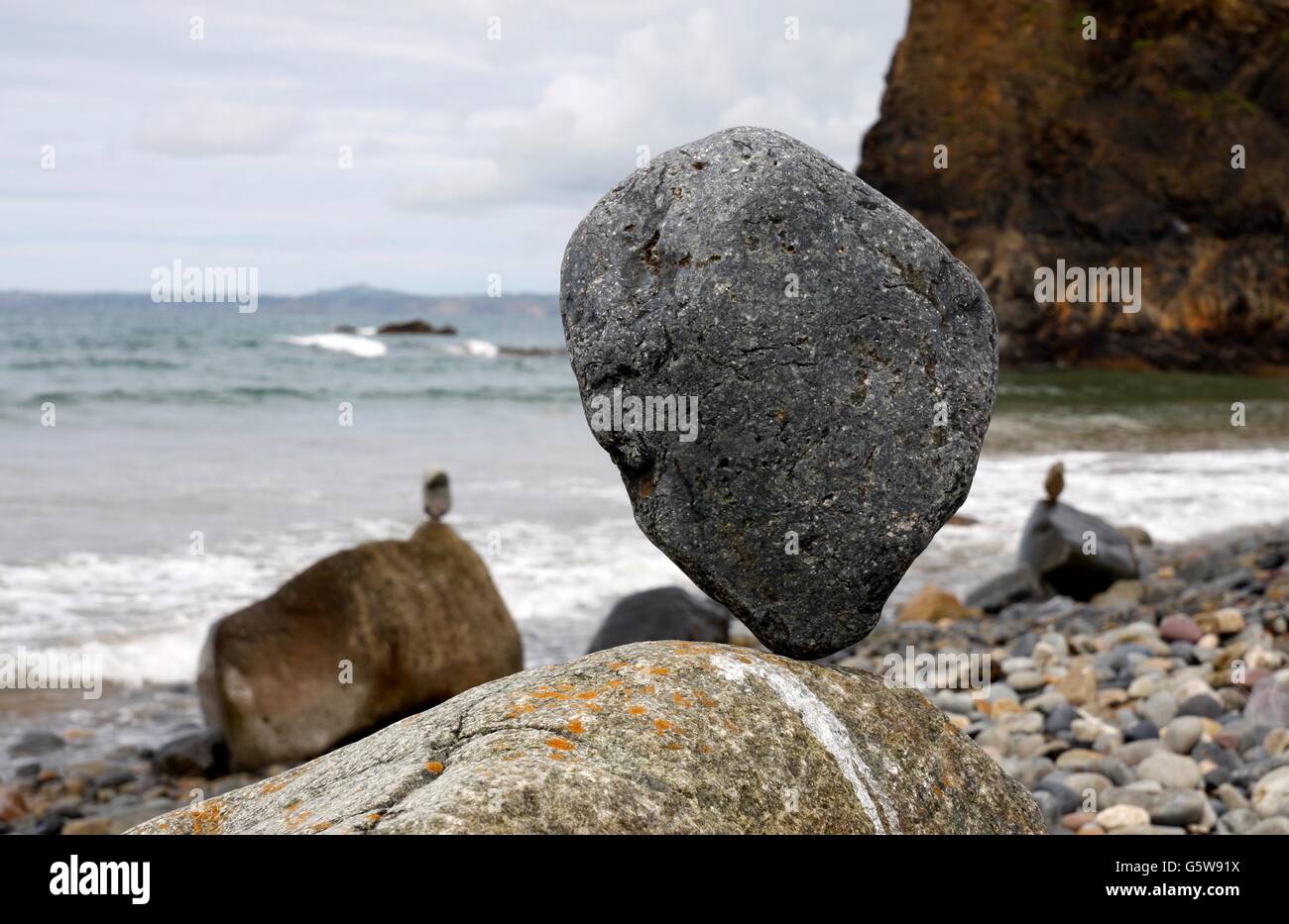 Stones balanced on a pebble beach Stock Photo - Alamy