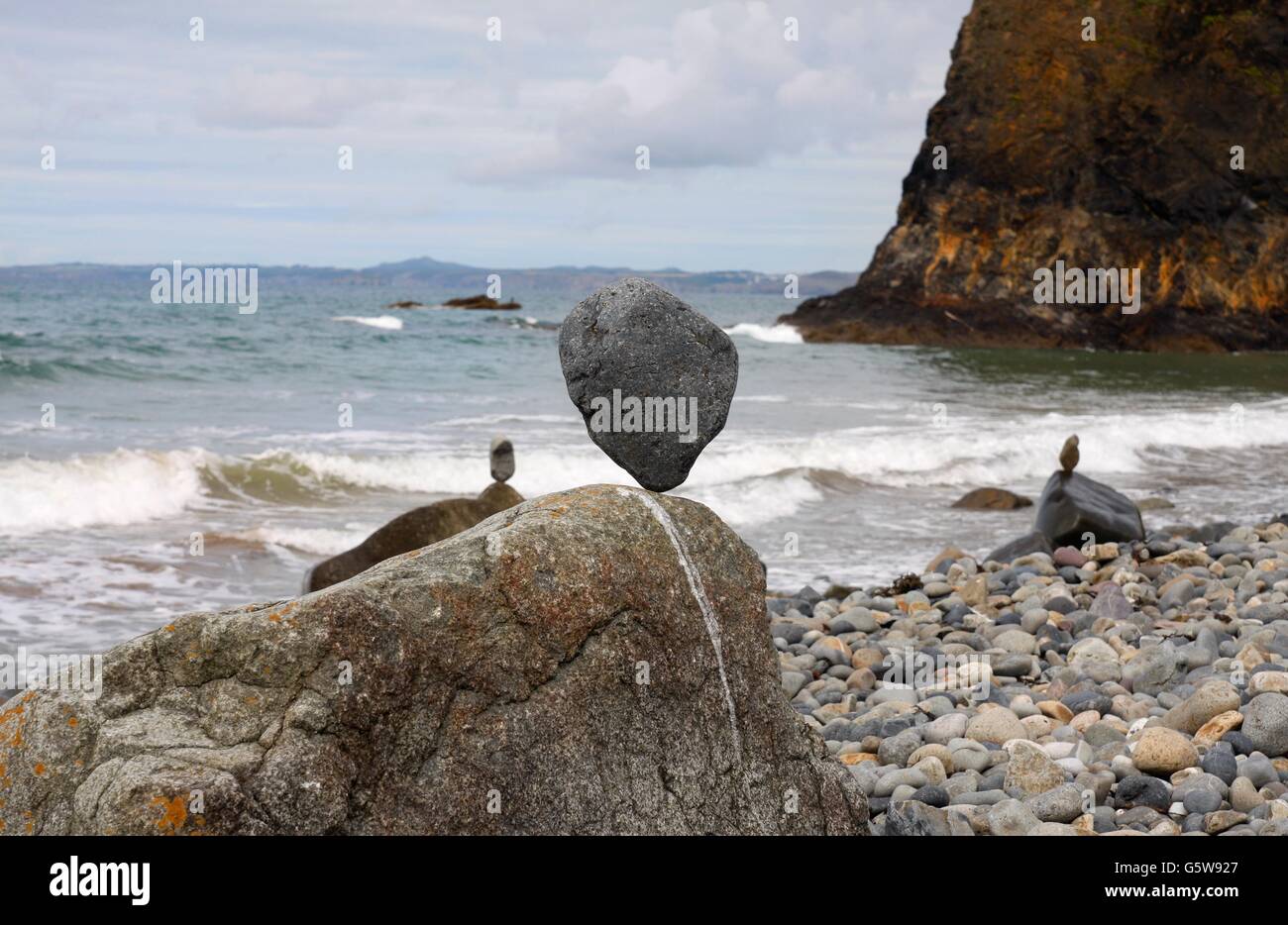 Stones balanced on a pebble beach Stock Photo - Alamy
