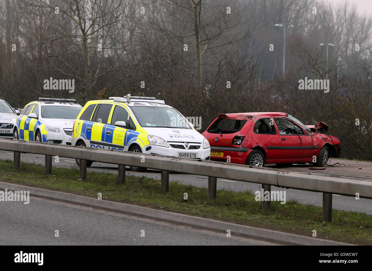 The wreckage of a red Ford Fiesta remains at the scene of a fatal car ...