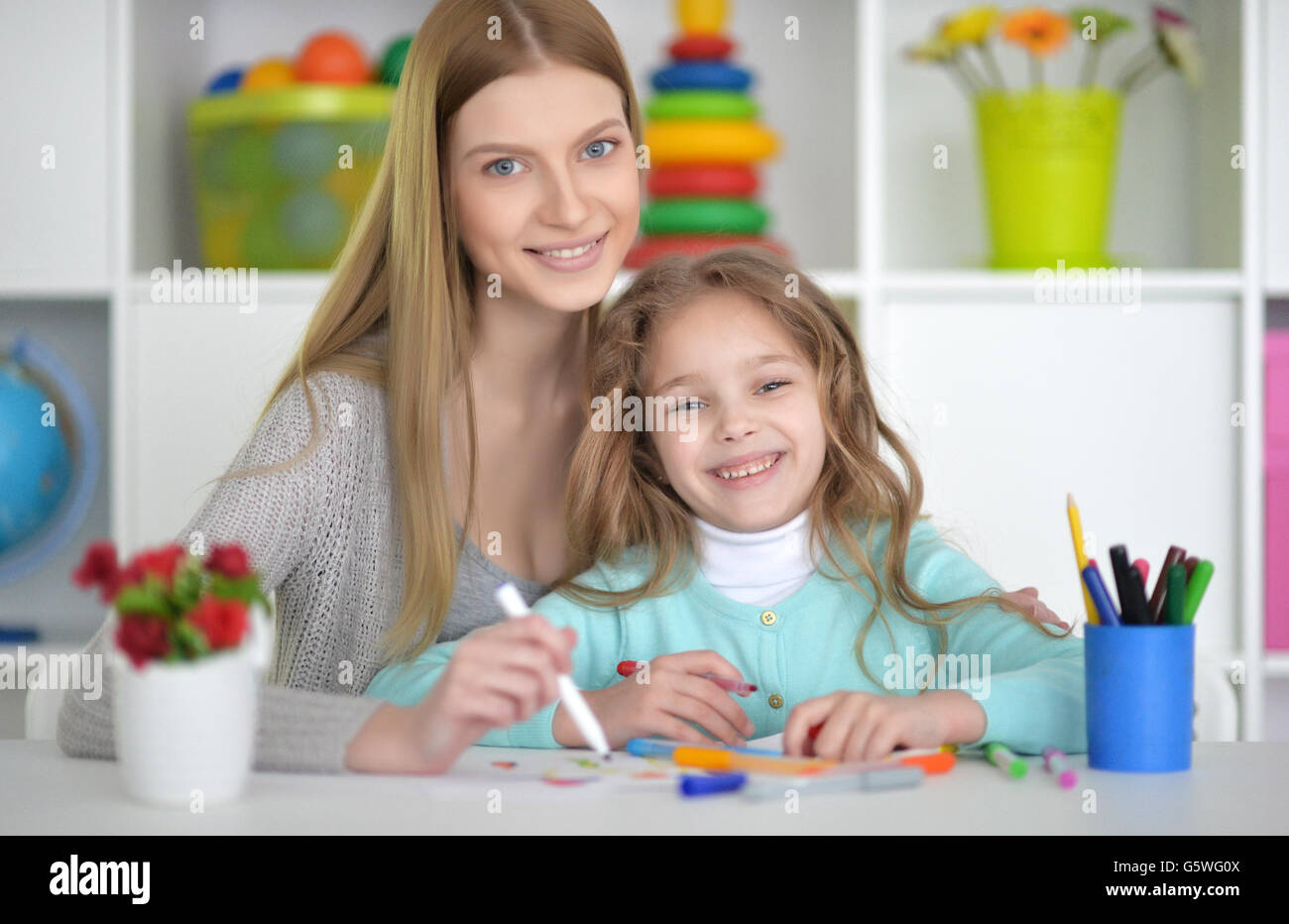 Elementary school art class with beautiful teacher Stock Photo - Alamy