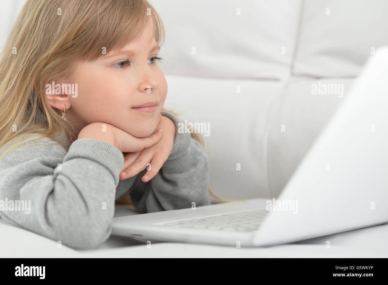 Portrait of a cute Little girl using computer Stock Photo - Alamy