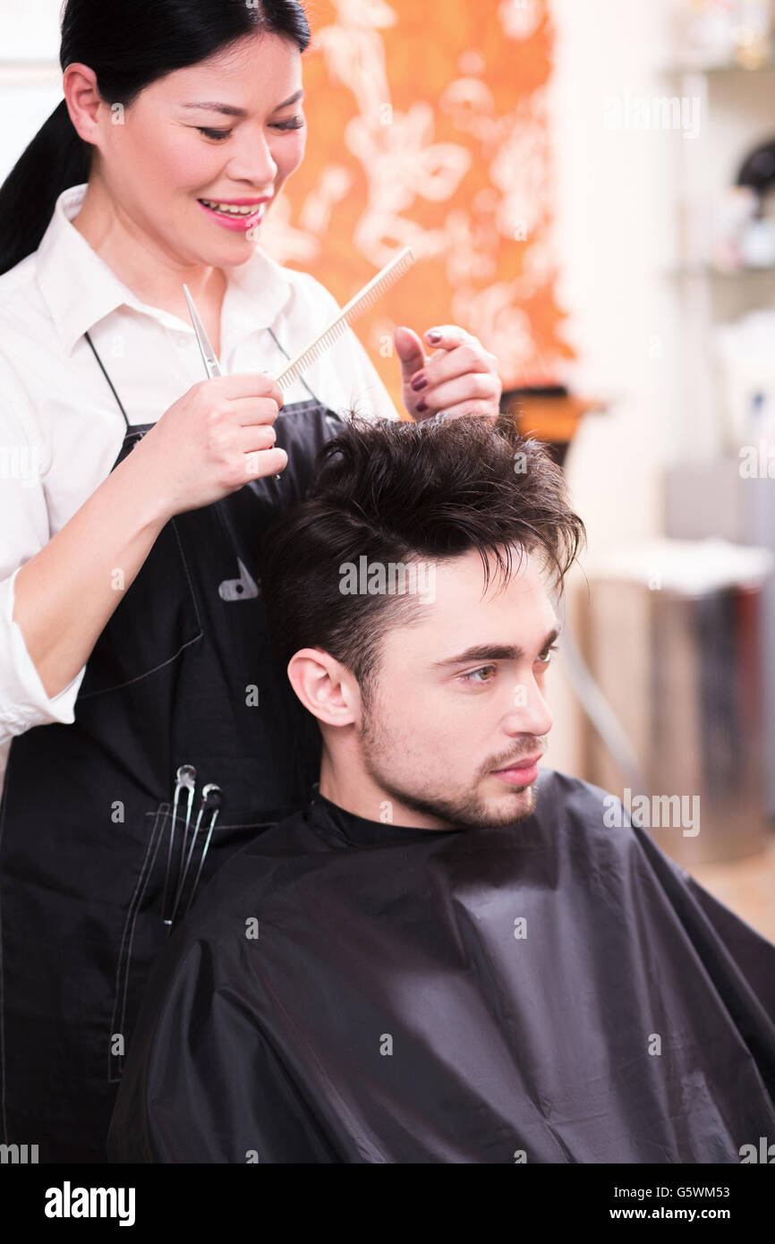 Handsome man in hairdressing saloon Stock Photo - Alamy