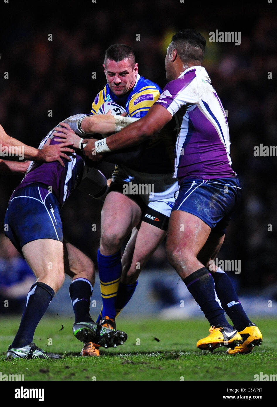 Leeds Rhinos' Ian Kirke is tackled by Melbourne Storm's Ryan ...