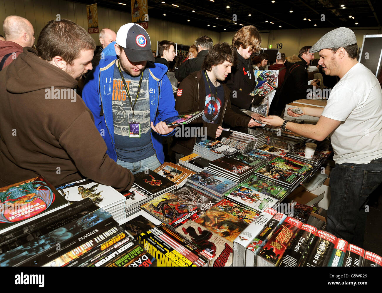 A group of fans study the books and comics on sale at the annual London ...