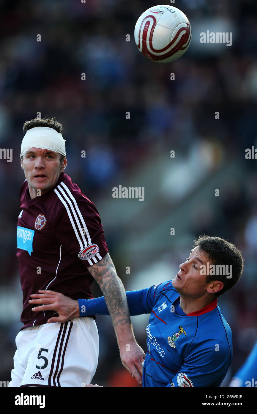 Heart's Darren Barr and Inverness' Gary Warren (right) jump for the ...