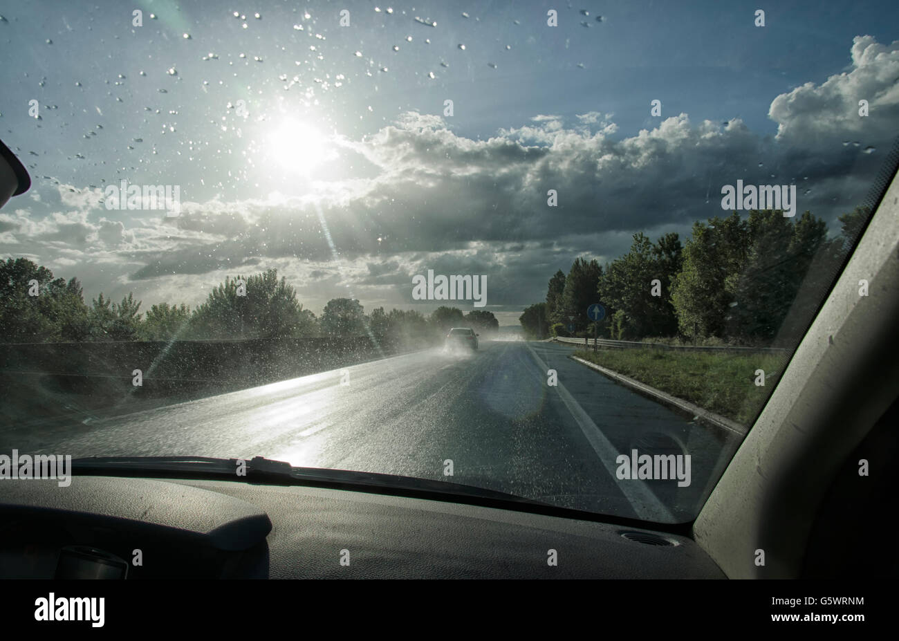 Inside view of car on a wet highway Stock Photo - Alamy