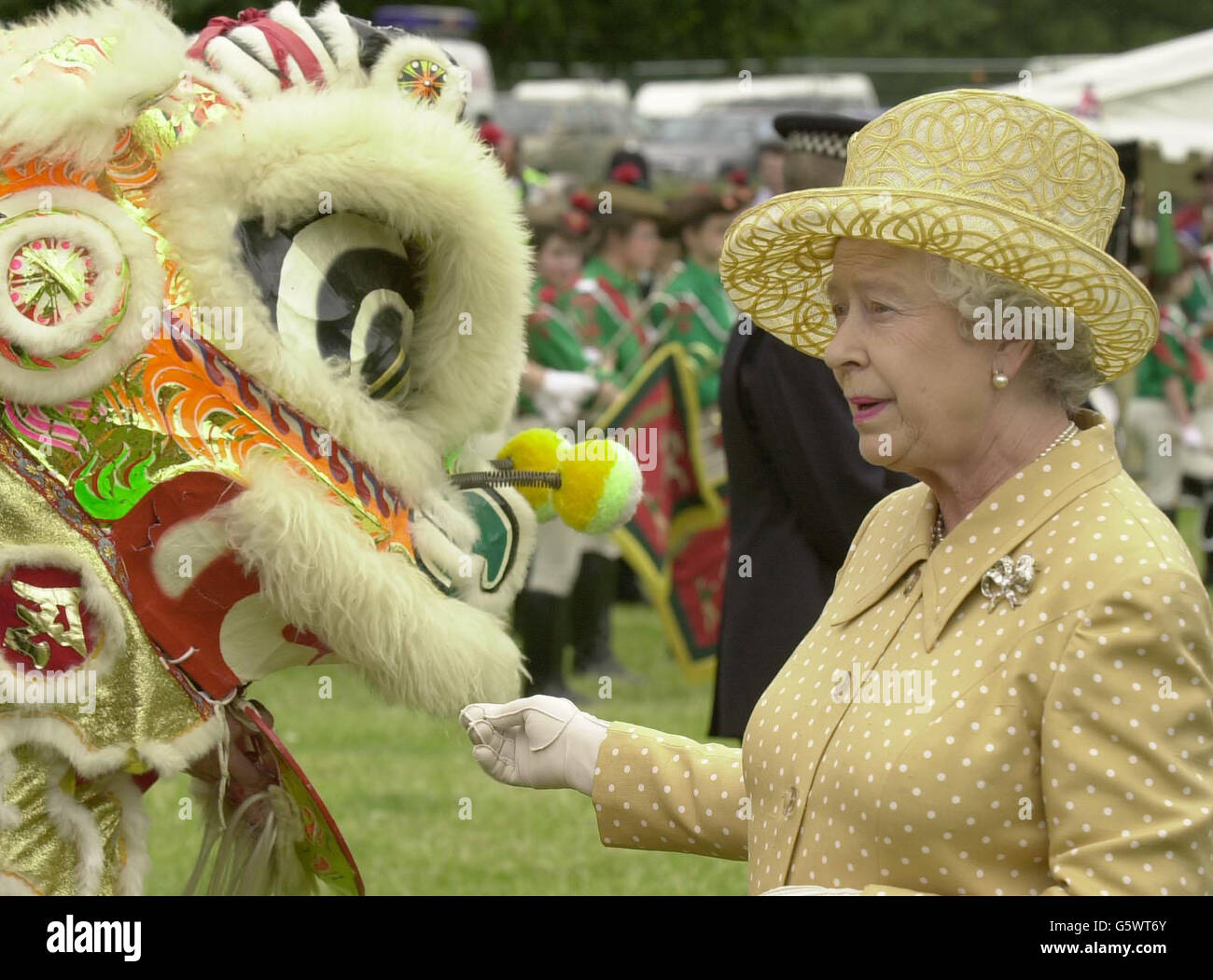 Britain's Queen Elizabeth II comes face to face with a Chinese dragon ...