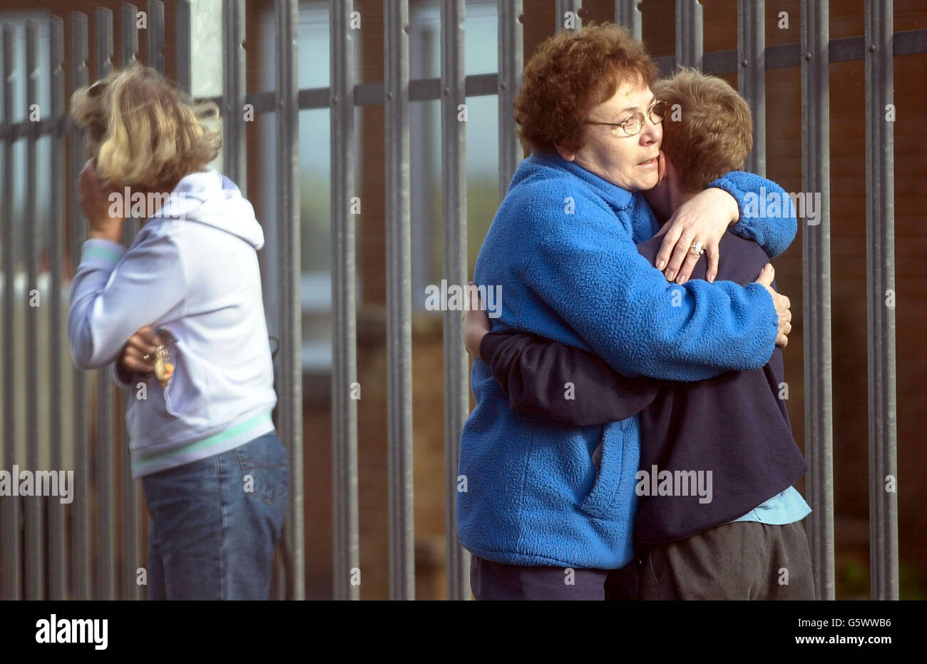 Parents and children comfort each other outside the Largs Academy ...