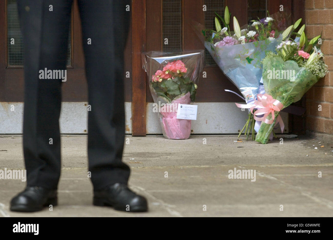 Flowers lie outside the Largs Academy school in Largs, following a ...