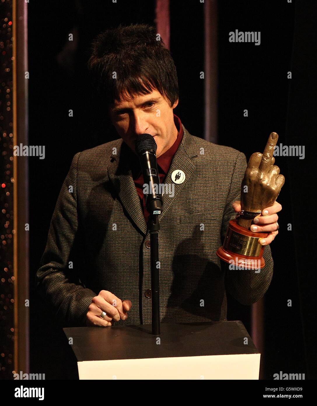 Johnny Marr collects the Godlike Genius Award on stage during the 2013 ...