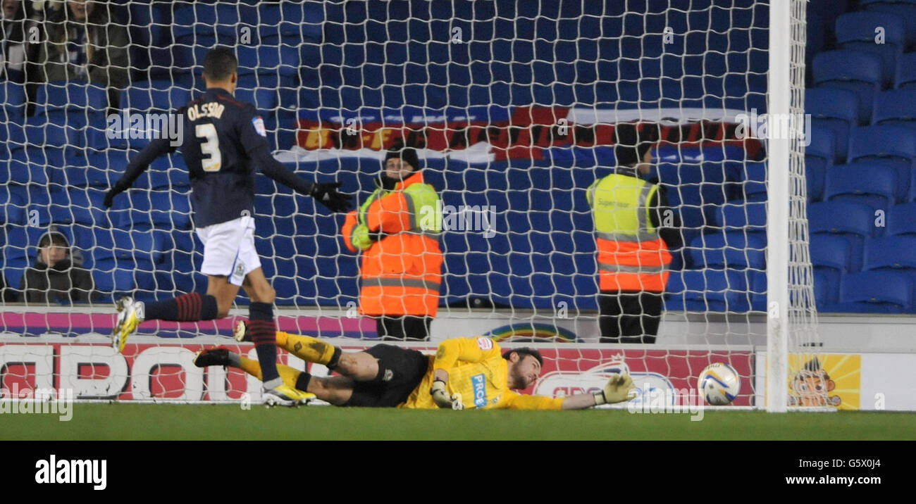 Blackburn Rovers' goalkeeper Jake Kean dives for a save alongside ...