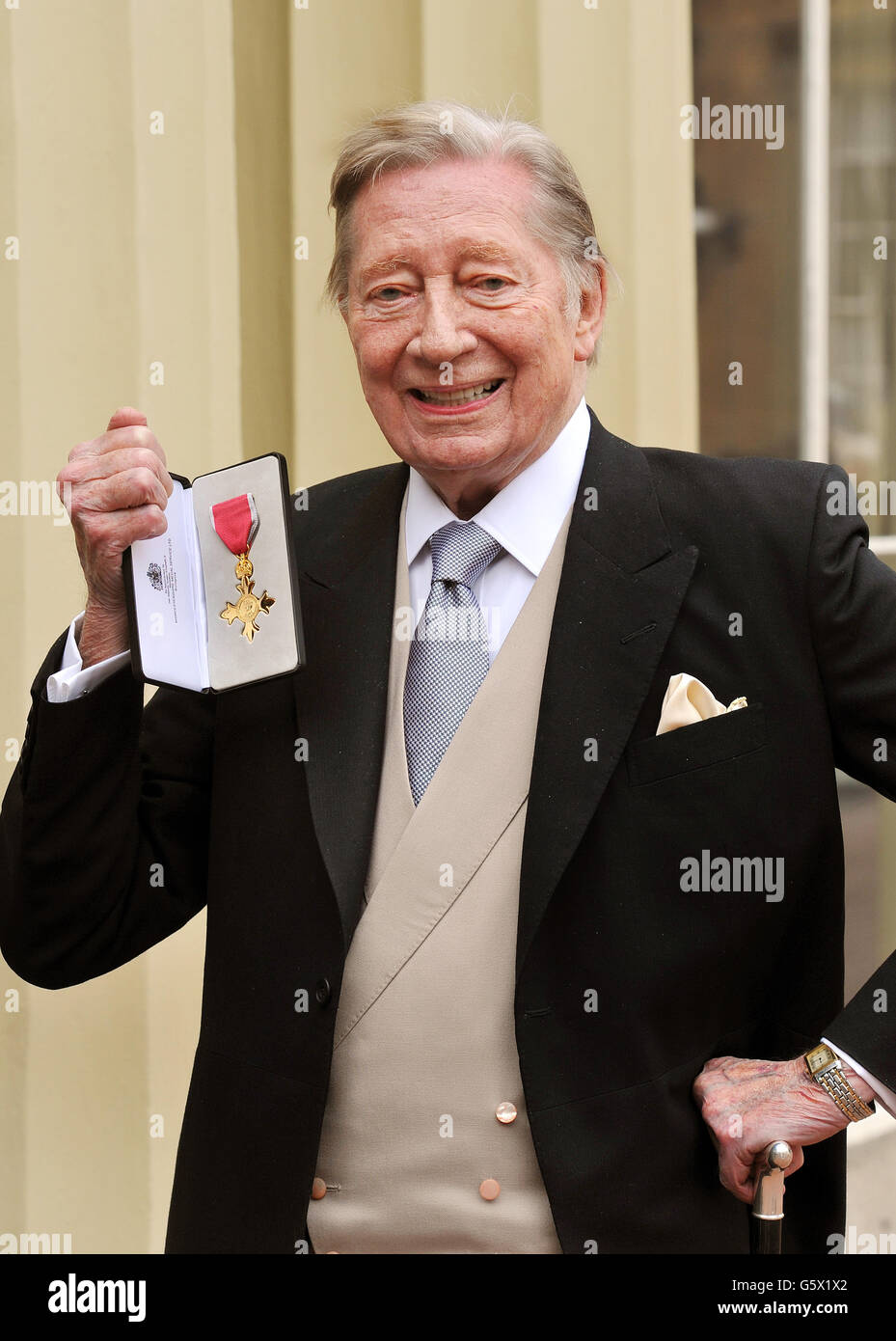 Jeremy Lloyd proudly holds his Officer of the British Empire (OBE ...