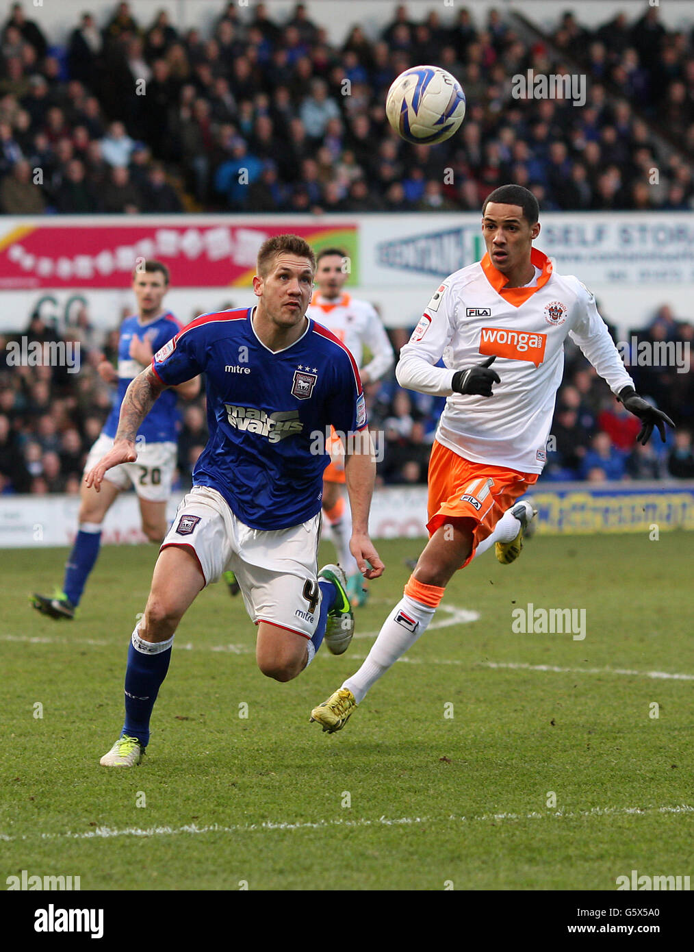 Ipswich Town's Luke Chambers (left) and Blackpool's Tom Ince compete ...