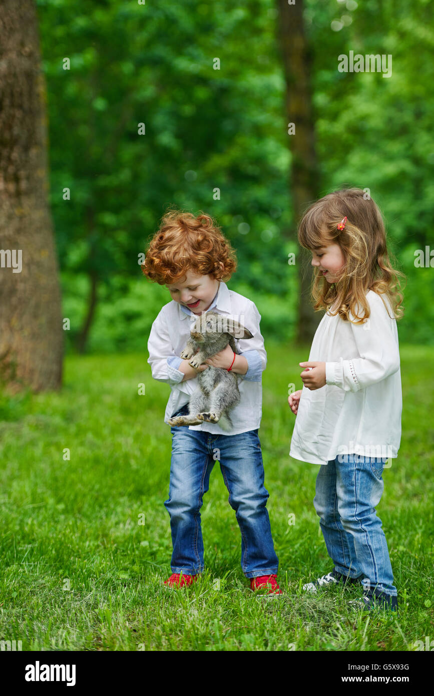 Boy girl playing pet rabbit hi-res stock photography and images - Alamy