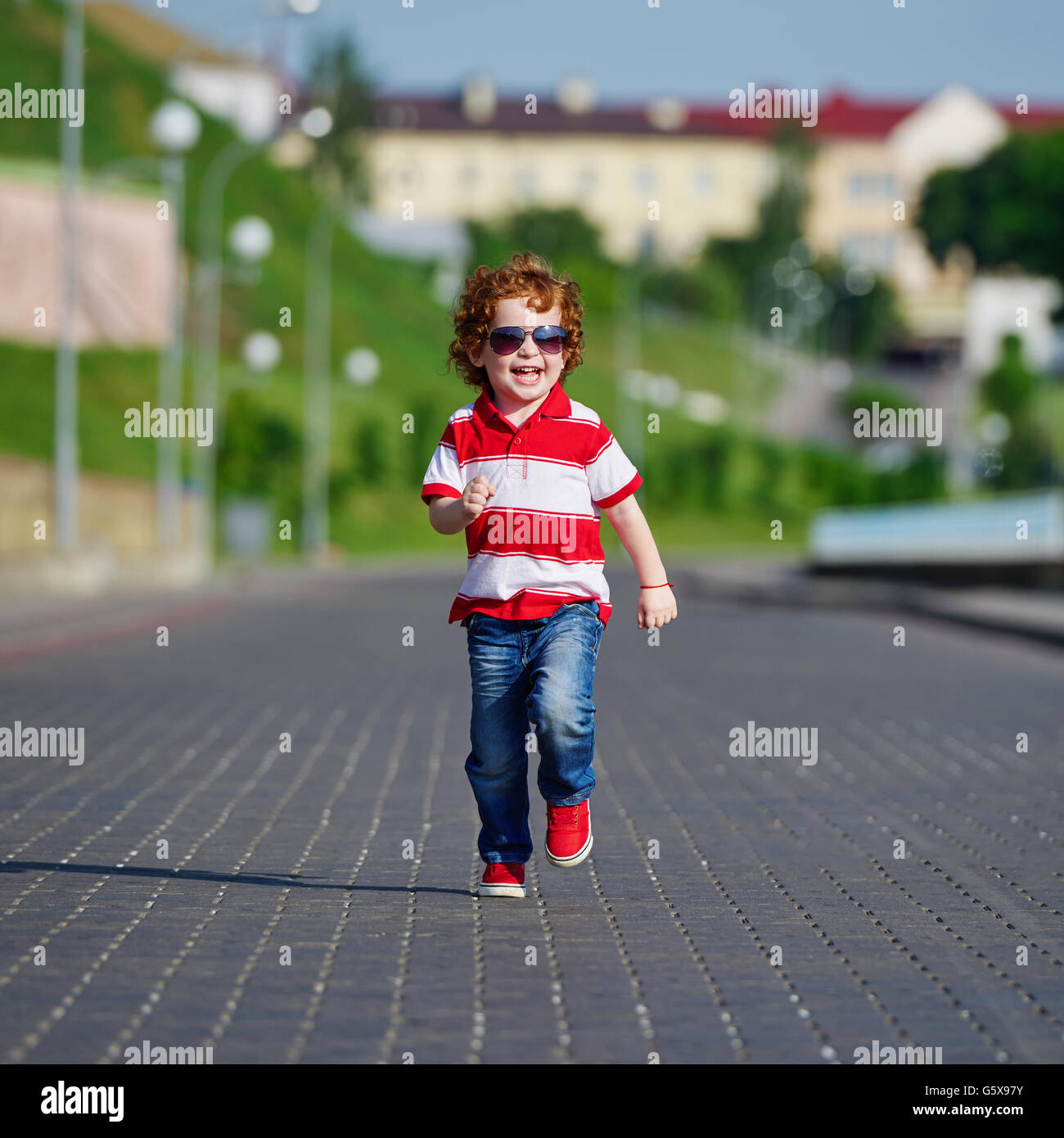 happy little boy walking on the street Stock Photo - Alamy