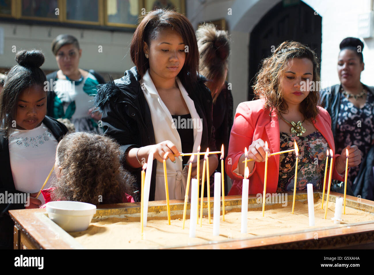 Children lighting candles in a church Stock Photo - Alamy