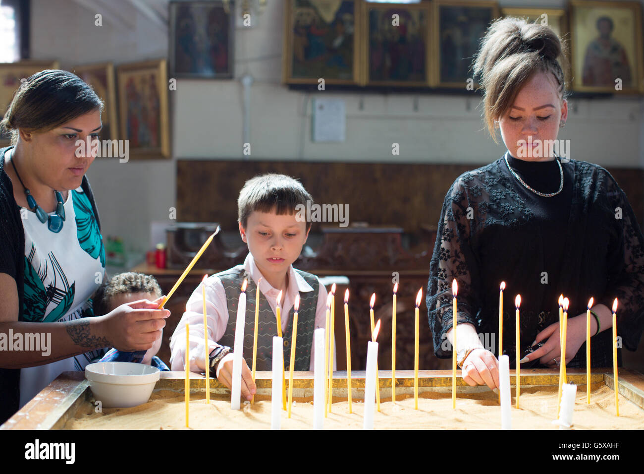 Children lighting candles in a church Stock Photo - Alamy